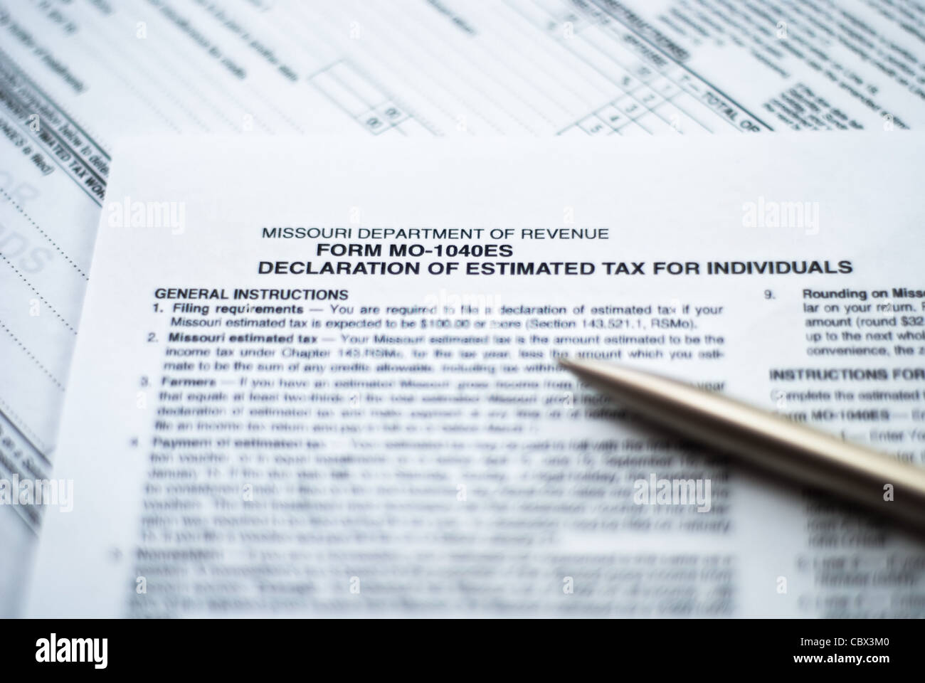 Filling out business documents on a desk Stock Photo - Alamy
