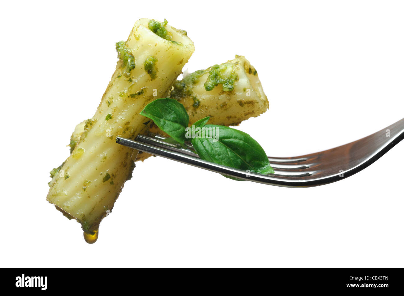 Typical italian pasta, rigatoni al pesto, with visible oil drop falling ...