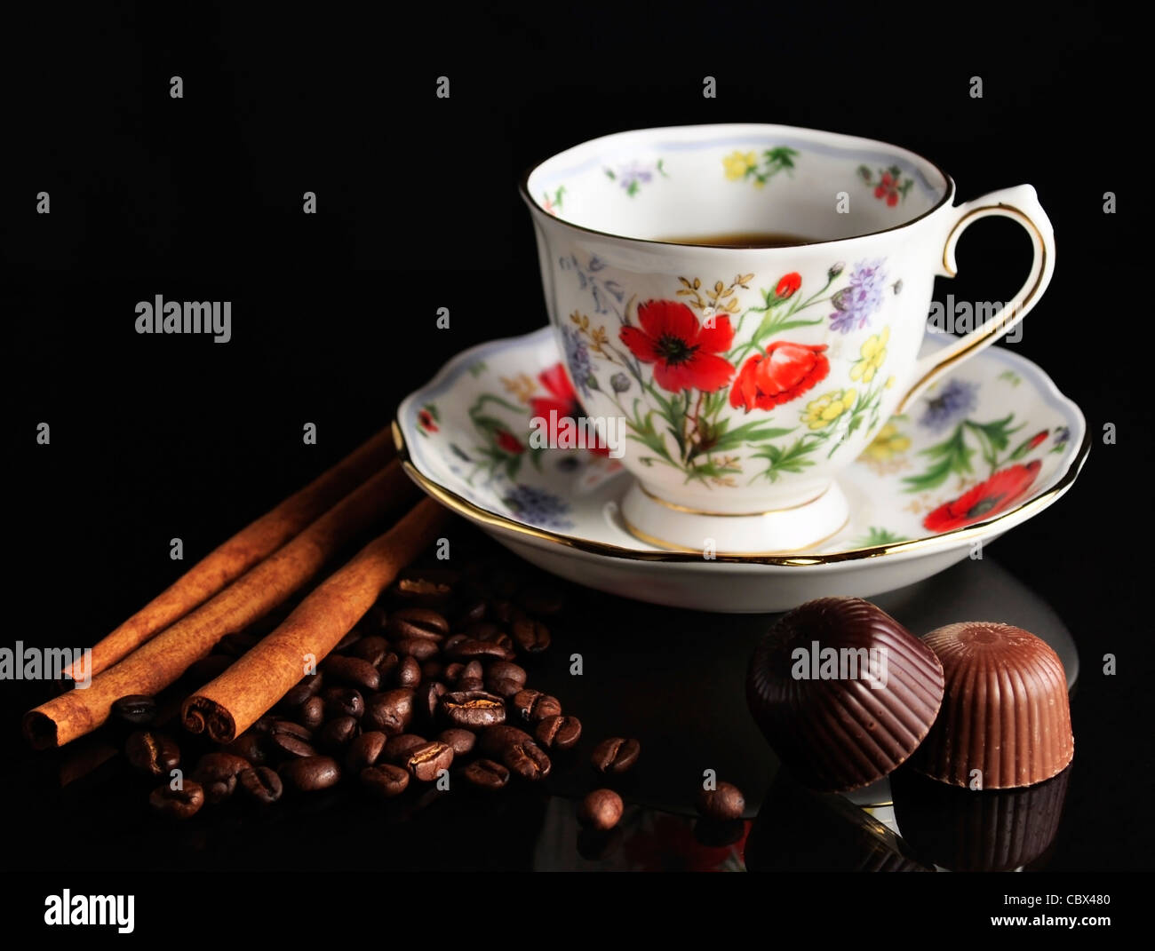 a cup of coffee , cinnamon sticks and chocolate candies Stock Photo - Alamy
