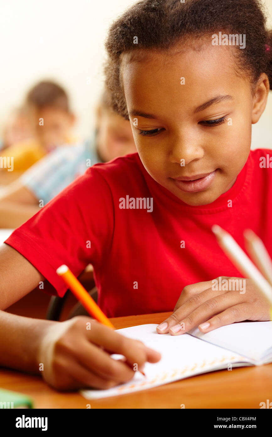 Portrait of lovely girl drawing with crayons at lesson Stock Photo - Alamy