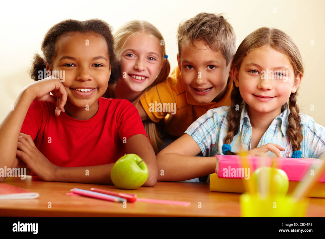 Portrait of smart schoolchildren looking at camera in classroom Stock ...