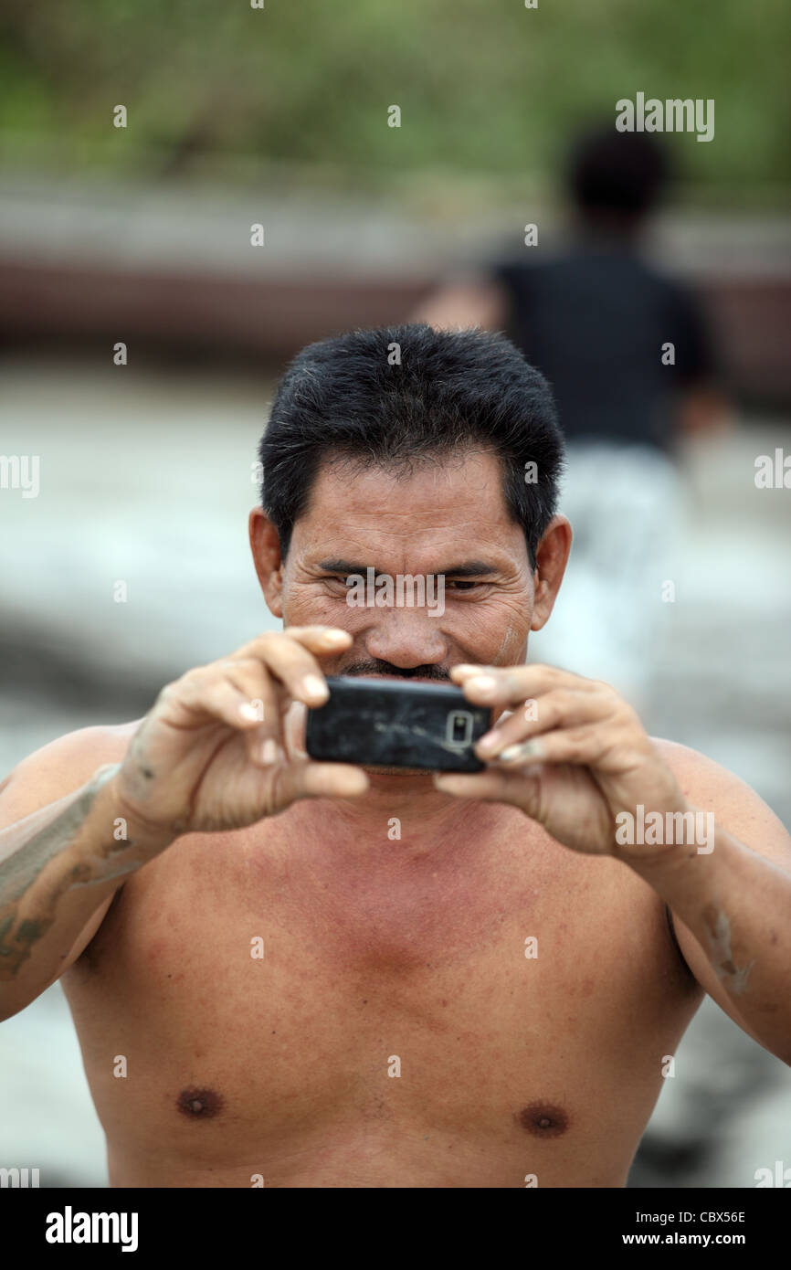 Local man taking a photo at the Kampar river. Teluk Meranti, Riau ...