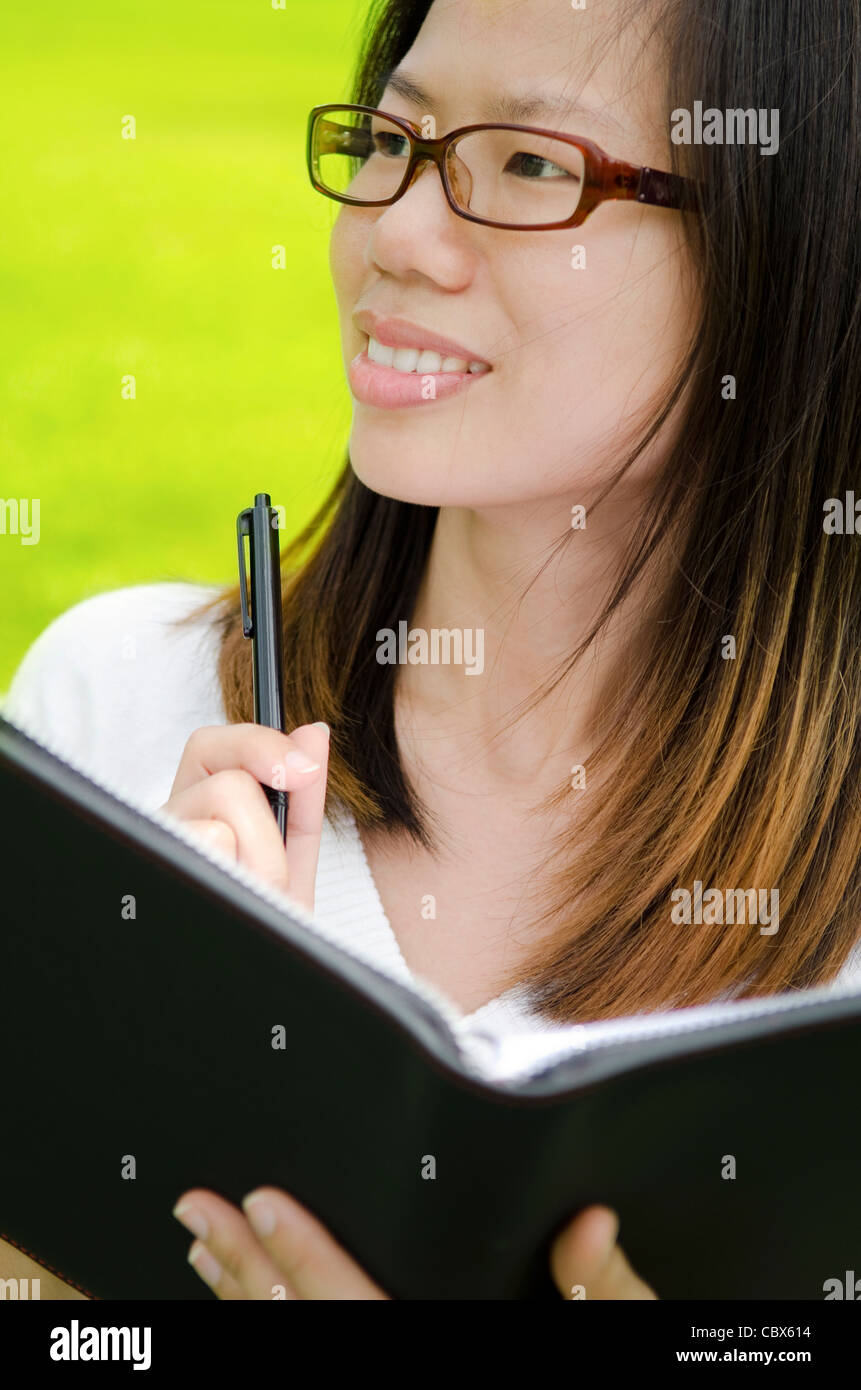 Asian student studying and writing at outdoors Stock Photo - Alamy