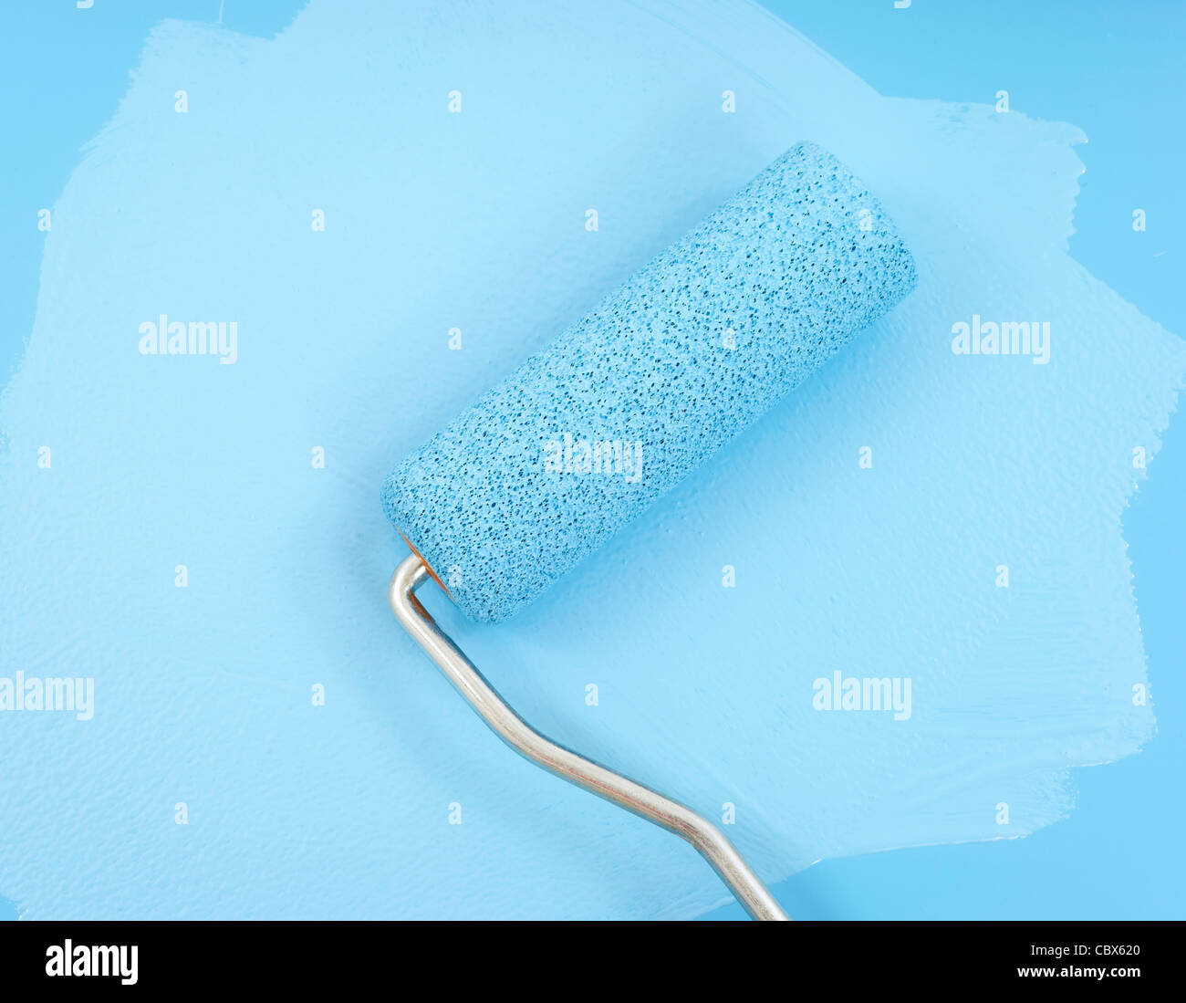 Paint roller and blue paint Stock Photo - Alamy