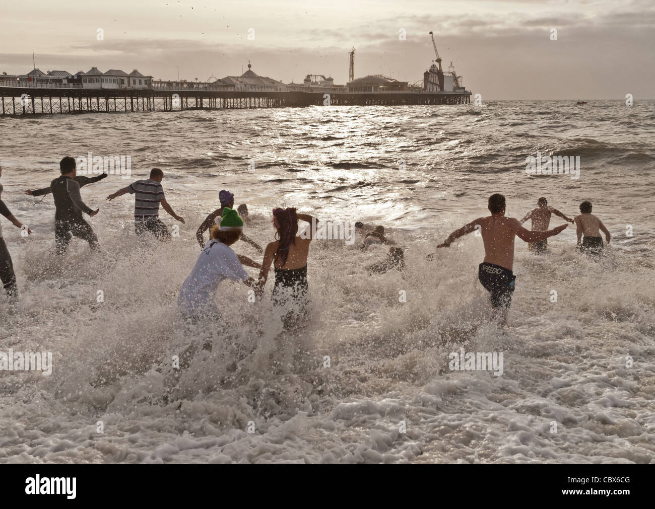 Swimmers running into sea Stock Photo - Alamy