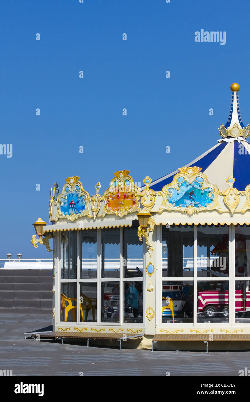Merry-go-round or roundabout at the beach on sunny day with blue sky ...