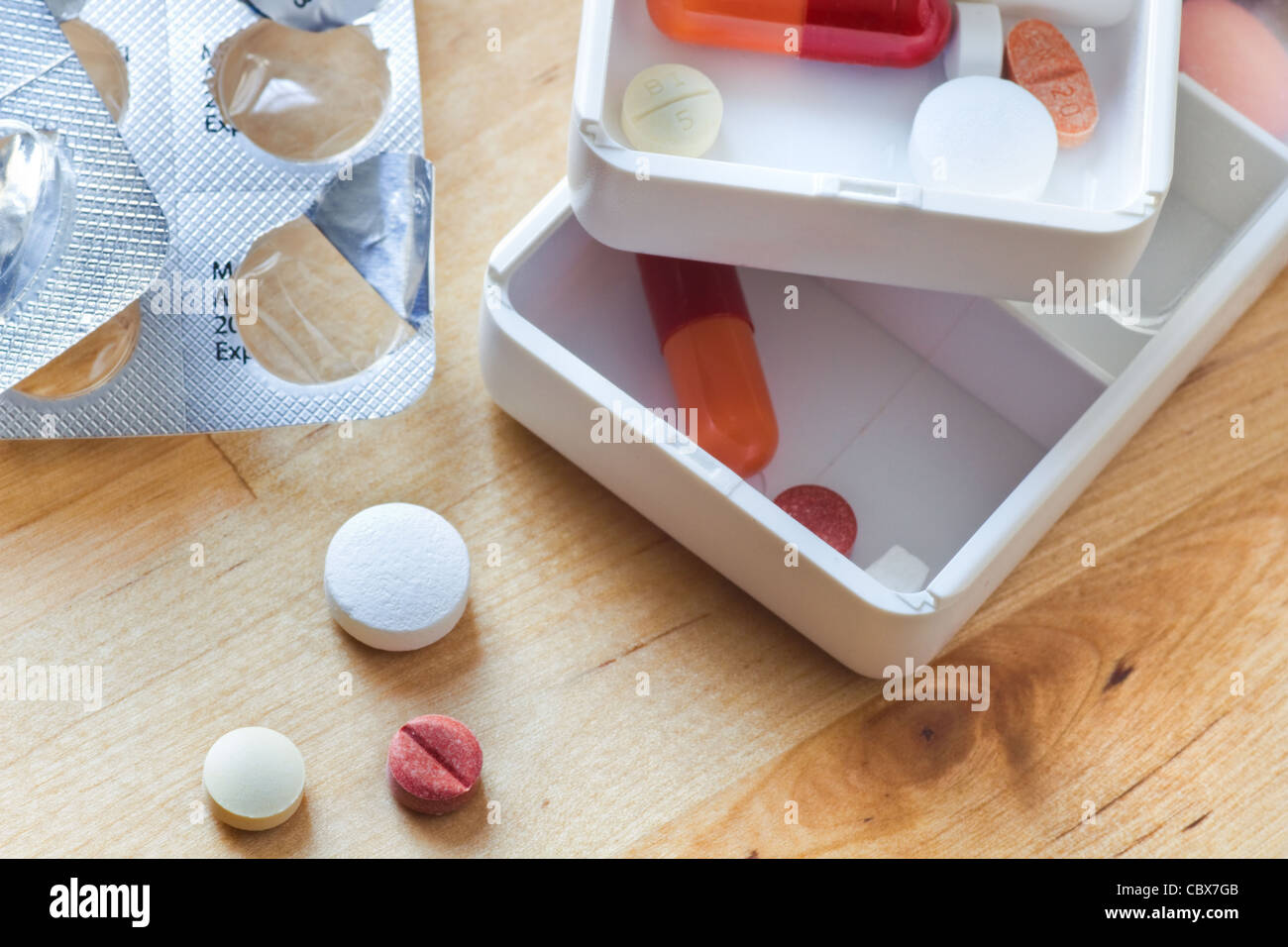 Tablets, capsules and pills sorted in pillboxes for daily use as ...