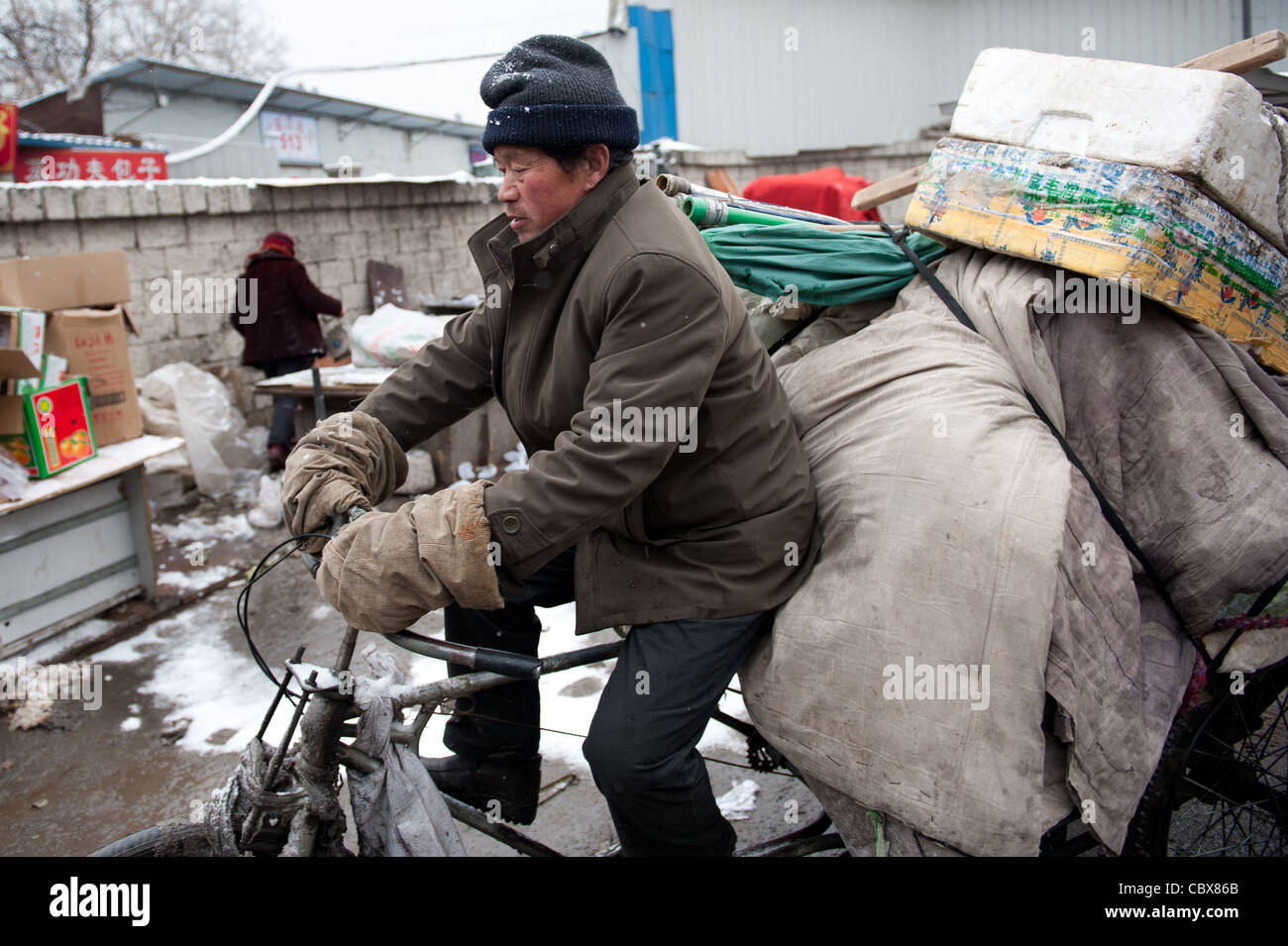 Chaoyangmen, Beijing. Vendor leaving with his merchandise after the ...
