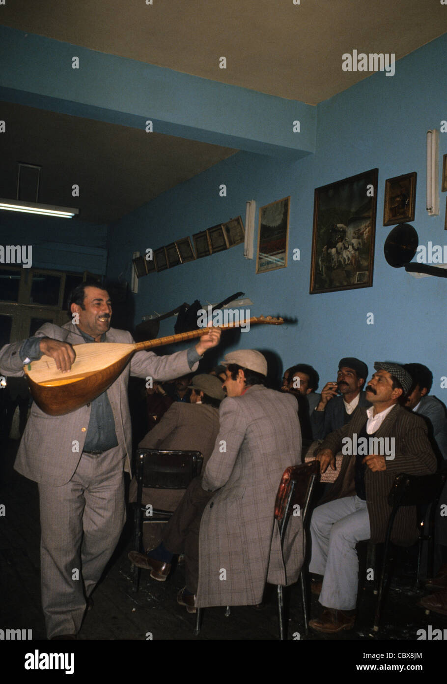 Kurdish men in a tea house in Kars, listen to a troubador (Asik ...