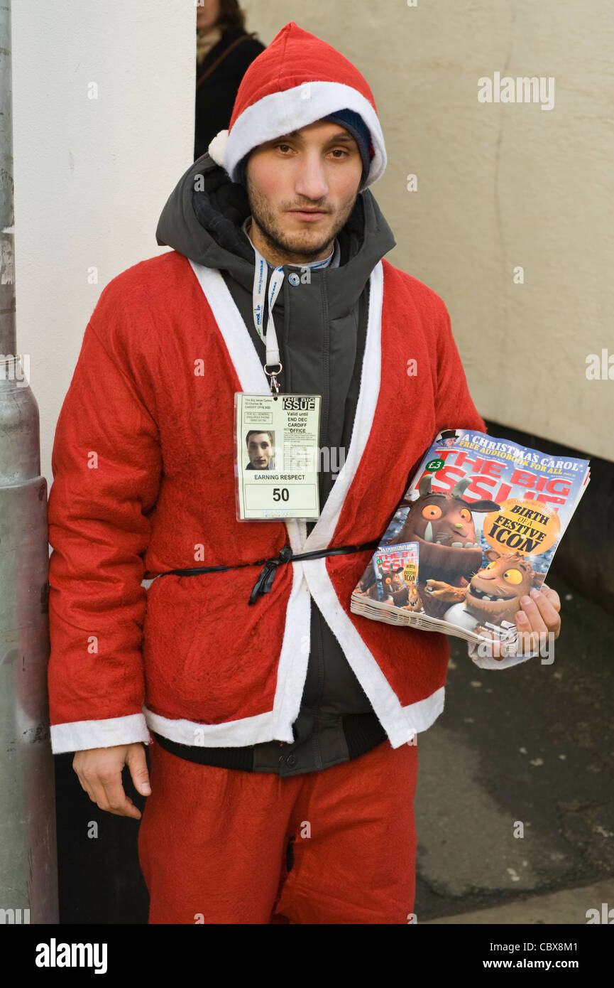 Big Issue seller in Father Christmas Xmas outfit in town centre of Hay ...