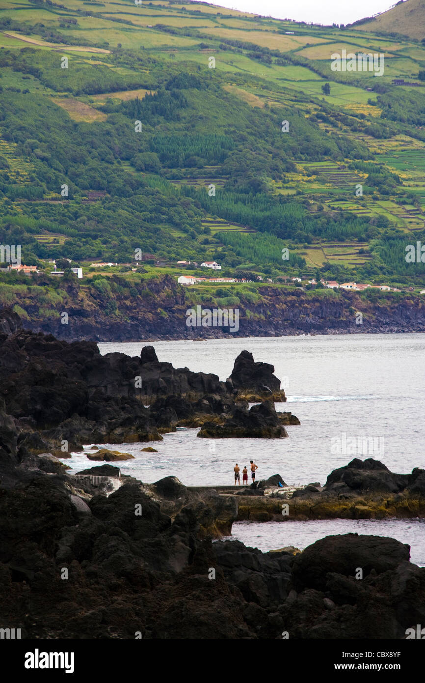 Children play in rock pools in the coastal town of Lajes do Pico, Pico ...