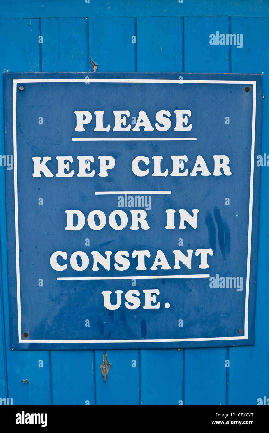 PLEASE KEEP CLEAR DOOR IN CONSTANT USE sign on blue door Hay-on-Wye ...