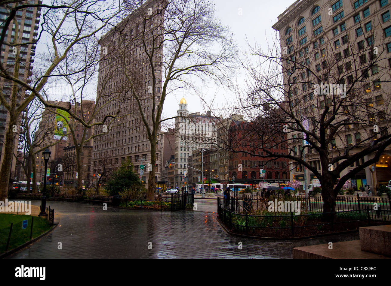 Flatiron building under the rain from the Madison Square park ...