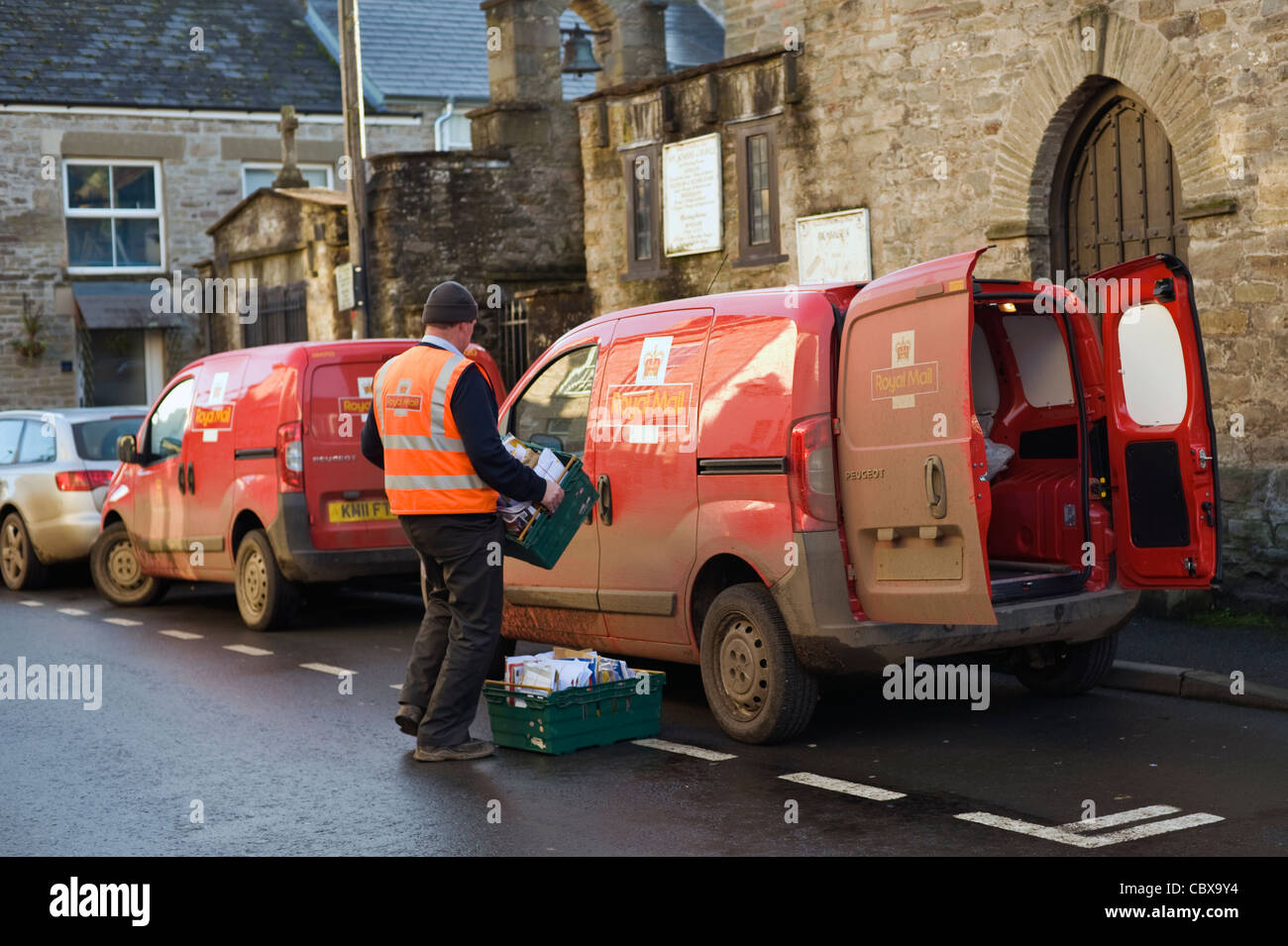 Postman loading delivery van in Hay-on-Wye Powys Wales UK Stock Photo ...