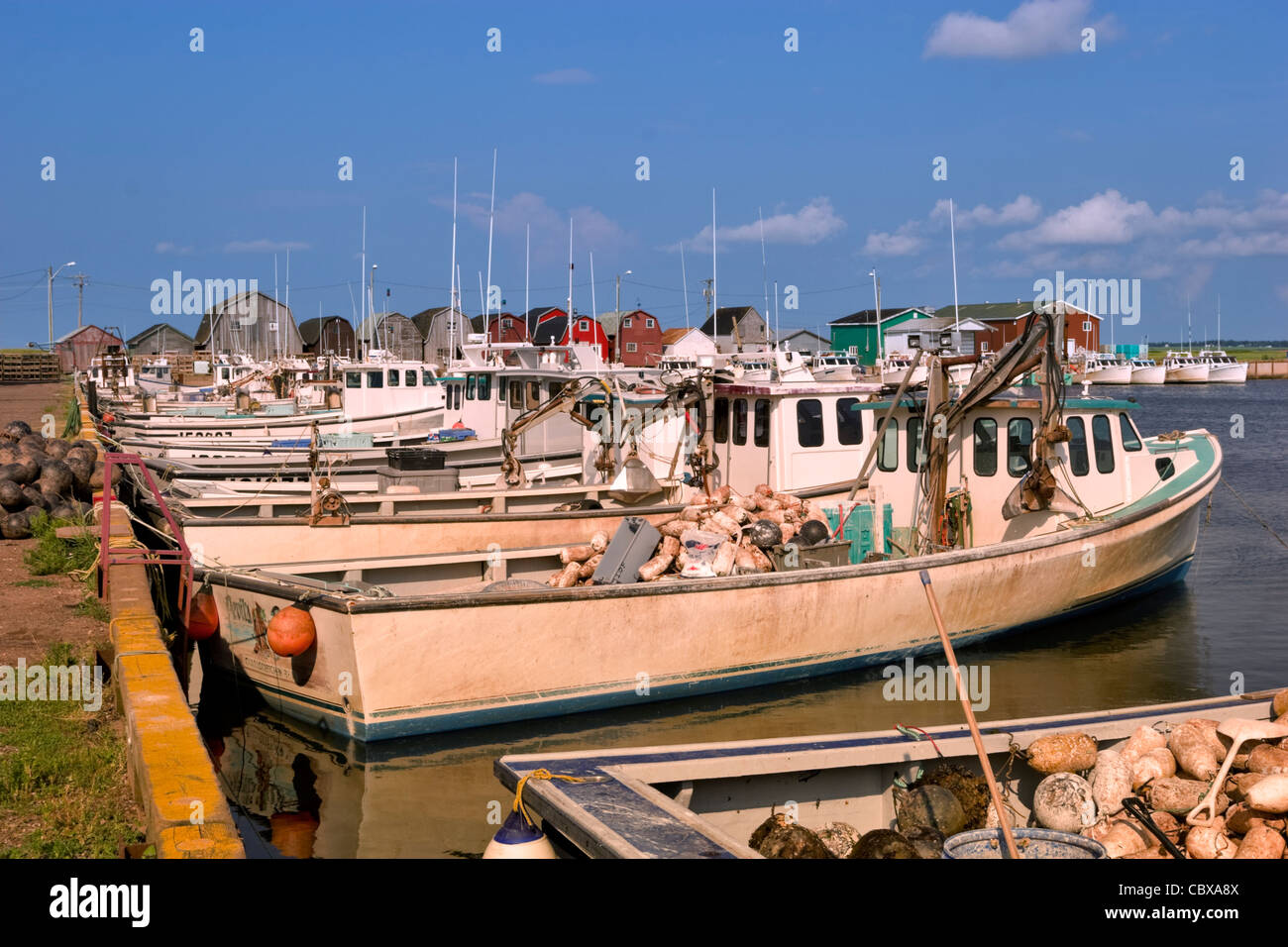 Fishing boats tied up in the harbour in Malpeque, Prince Edward Island ...