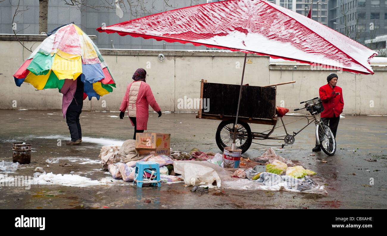 Chaoyangmen, Beijing. Vendors cleaning up after the morning market ...
