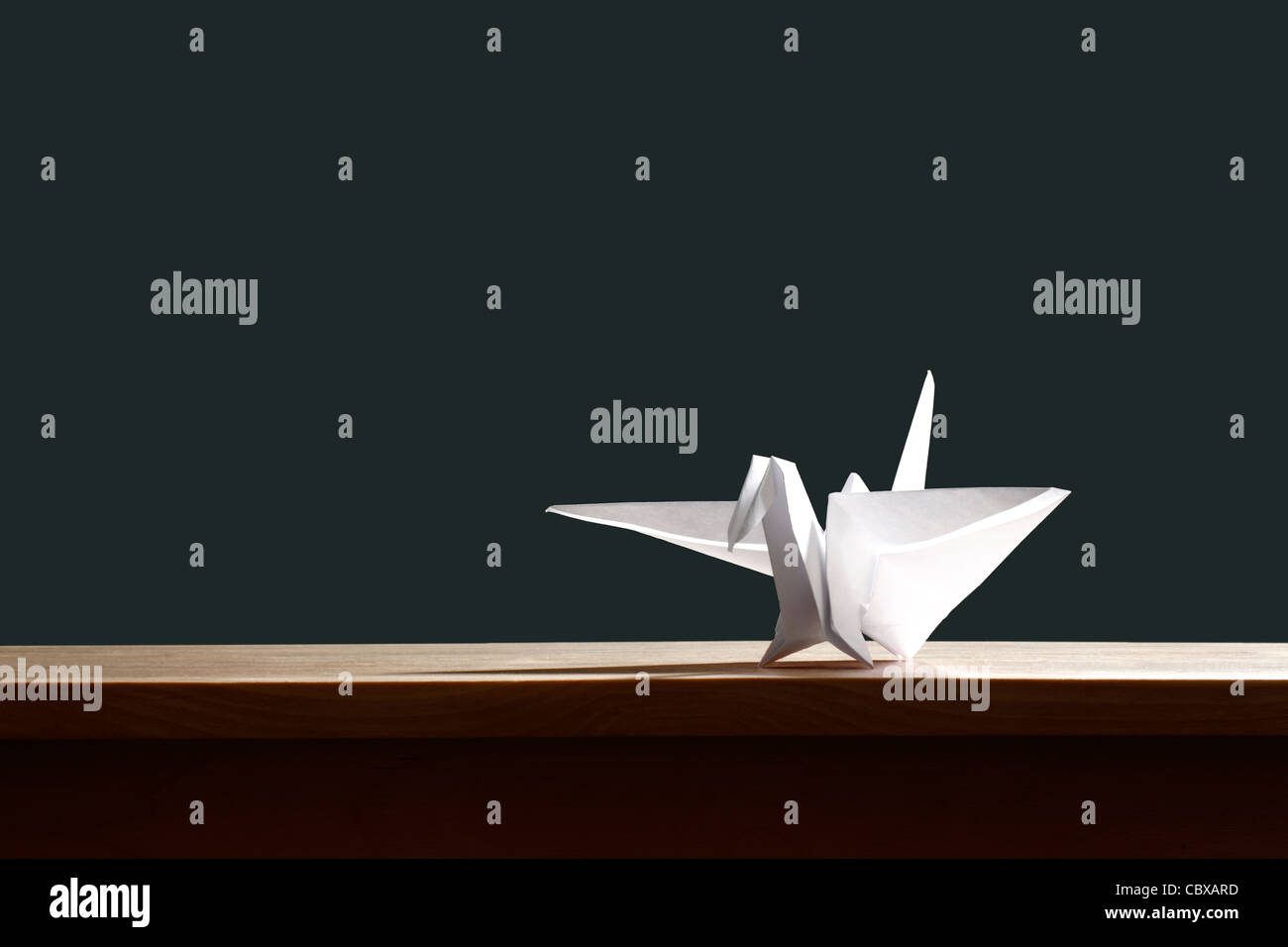 Origami bird on desk Stock Photo - Alamy