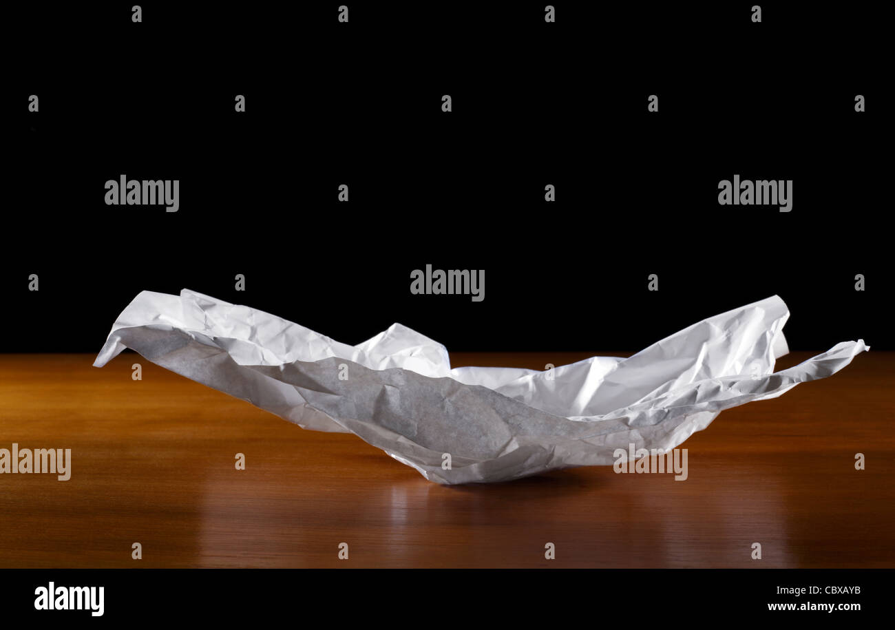 Crumpled paper on desk Stock Photo - Alamy