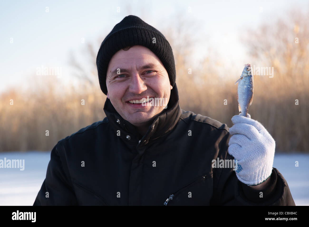 Ice fisherman with small fish Stock Photo - Alamy
