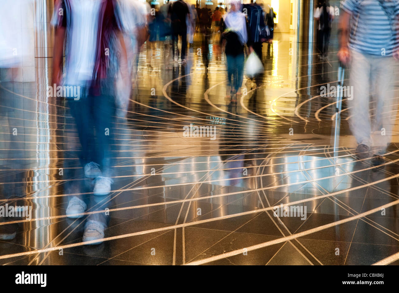 A shopping mall. Long exposure for intentional motion blur of people ...
