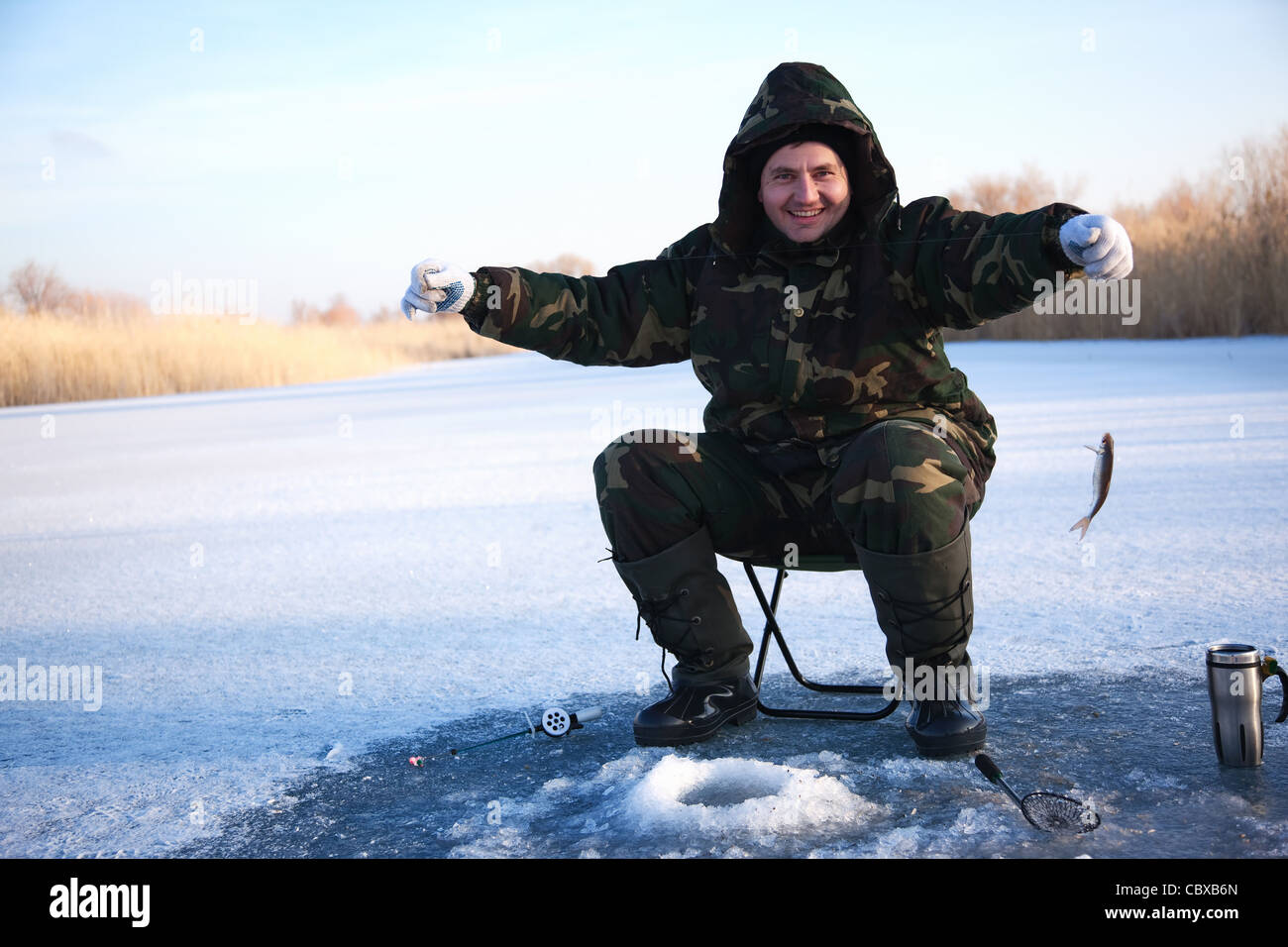 Ice fisherman on winter lake Stock Photo - Alamy