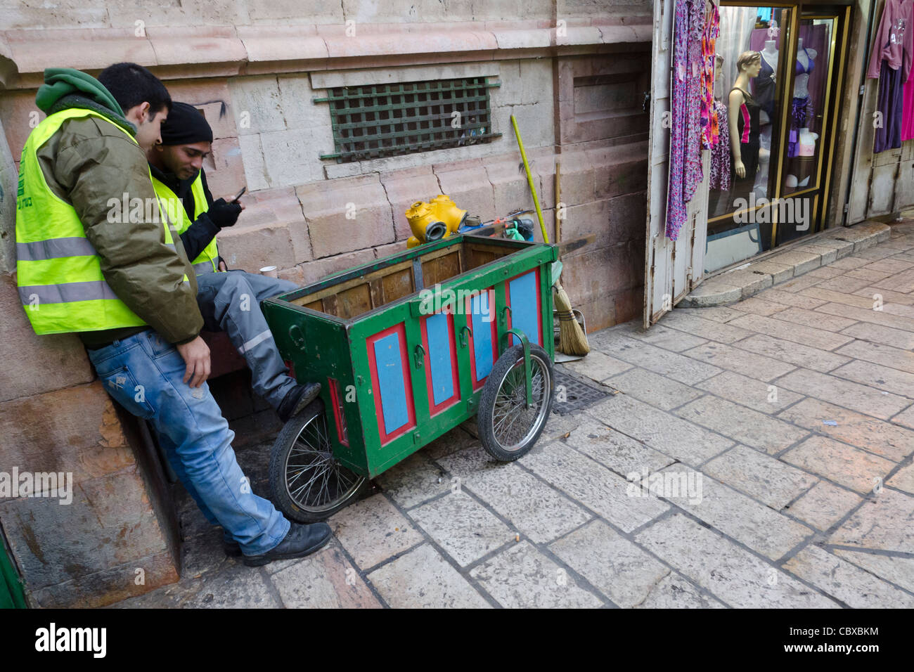 Two Palestinian street cleaners with trolley in the streets of ...