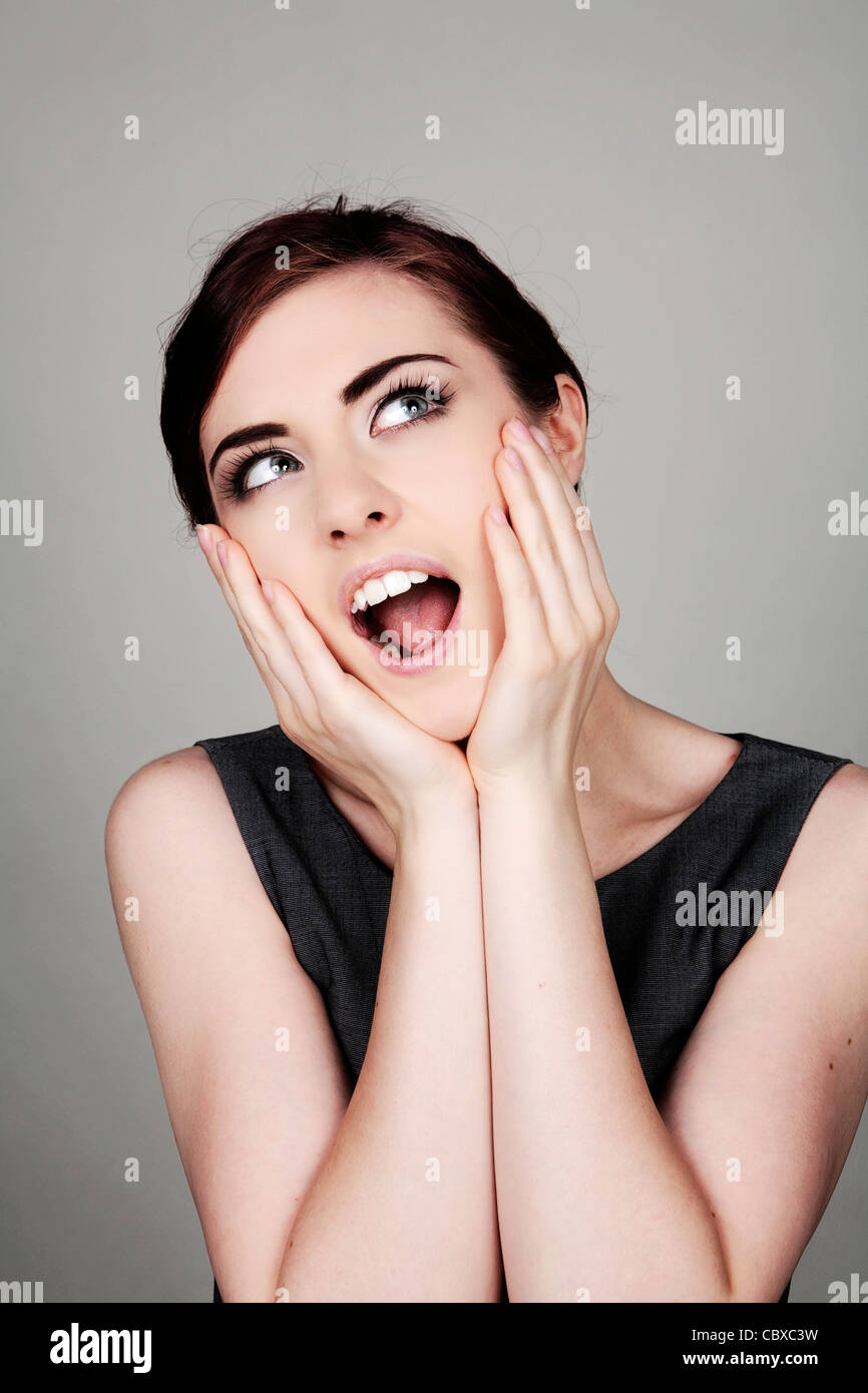 screaming woman with hands up to face Stock Photo - Alamy