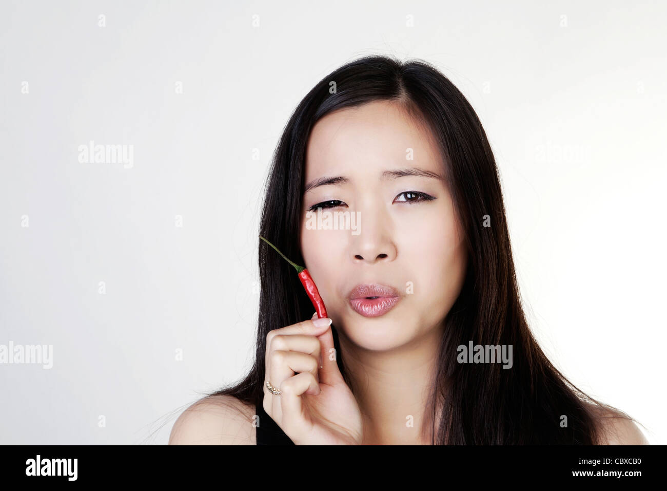 picture of lovely woman with a hot fresh chilli Stock Photo - Alamy