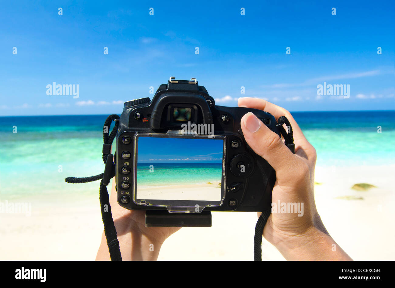 tourist holding camera on a beach island Stock Photo - Alamy