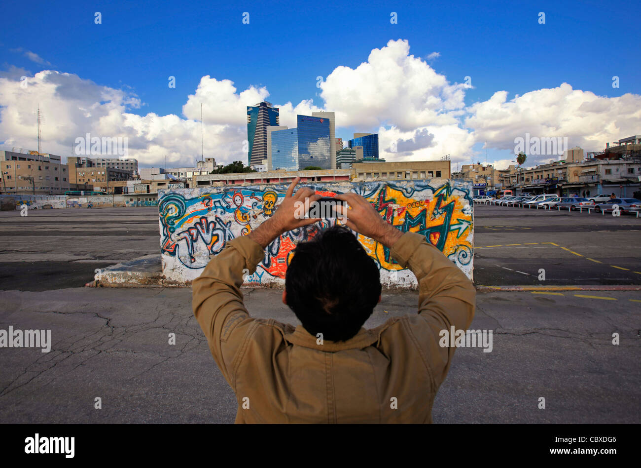 A man snapping with his iphone camera in the old bus station in Neveh ...