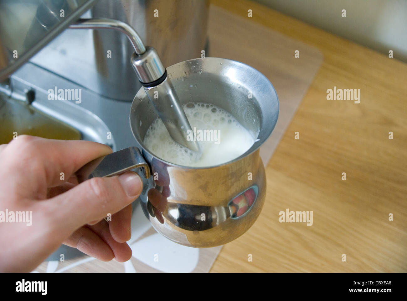 Steaming milk with a machine Stock Photo - Alamy