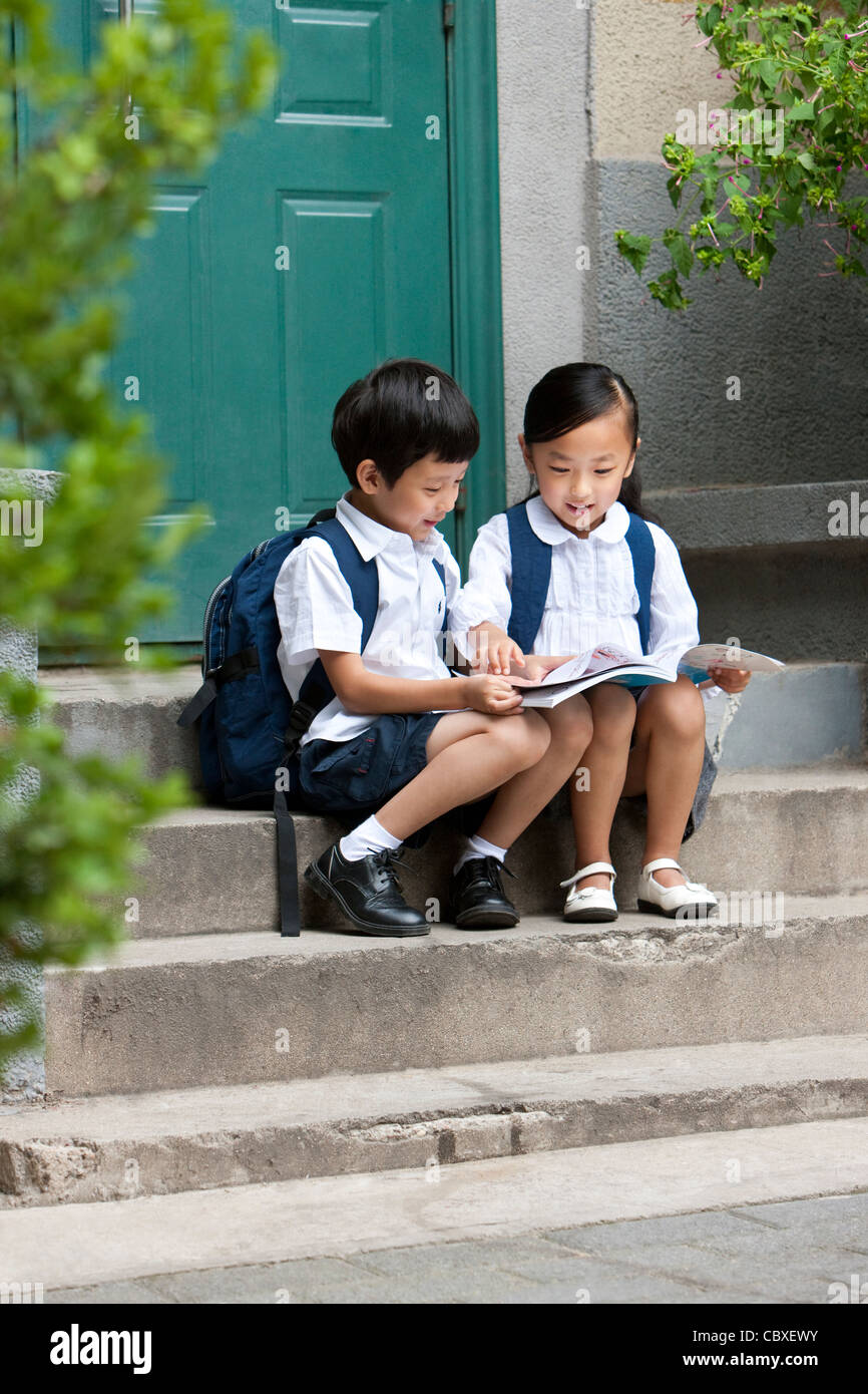 Two school children studying outside Stock Photo - Alamy