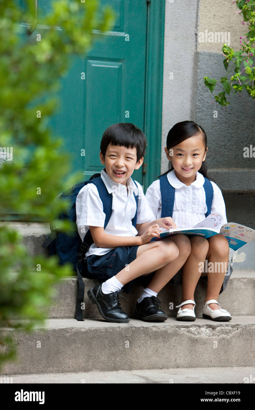 Two school children studying outside Stock Photo - Alamy