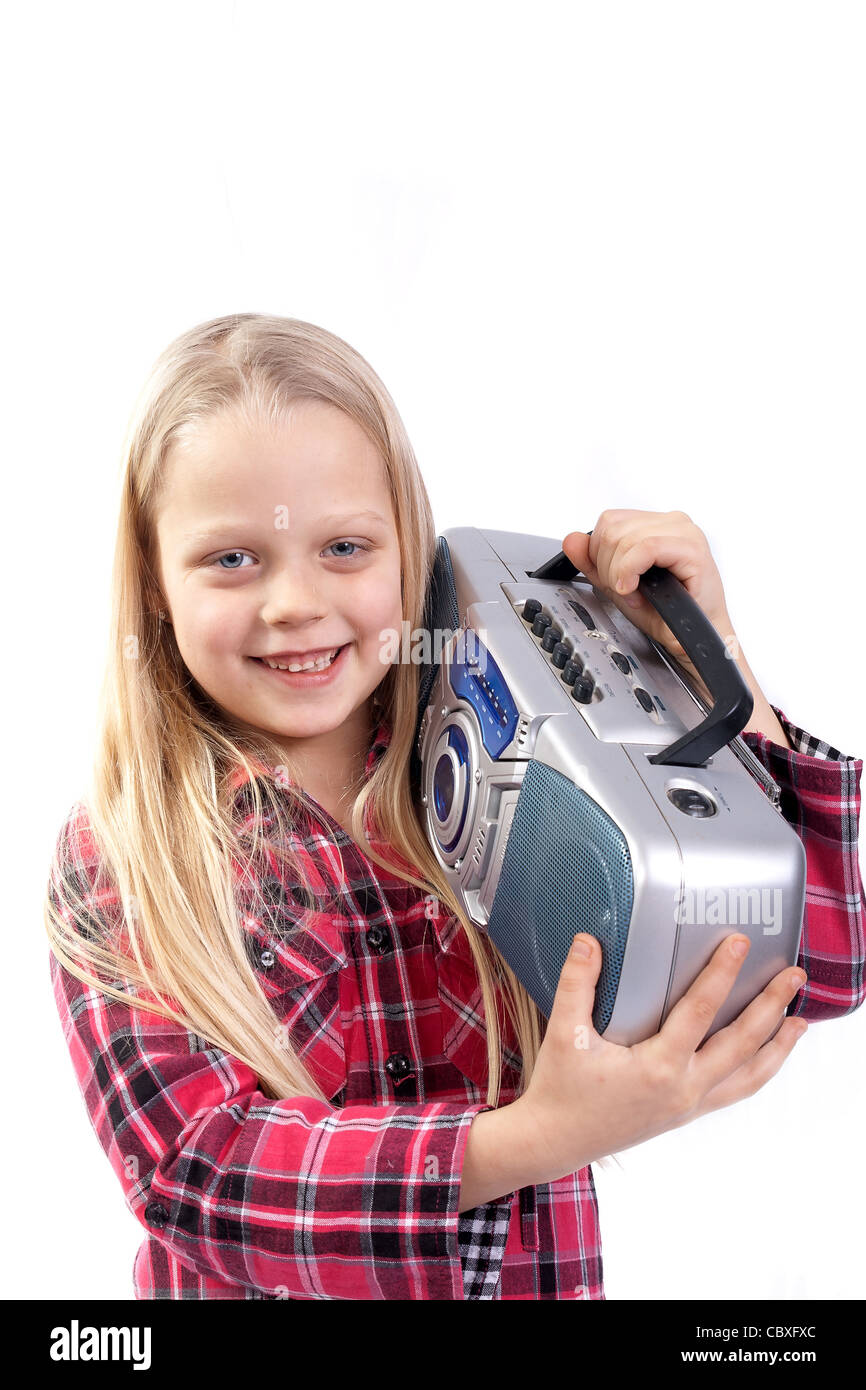 pretty little girl listening music and holding portable CD radio Stock ...