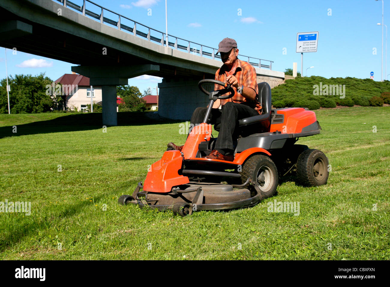 Worker driving lawn mower hi-res stock photography and images - Alamy