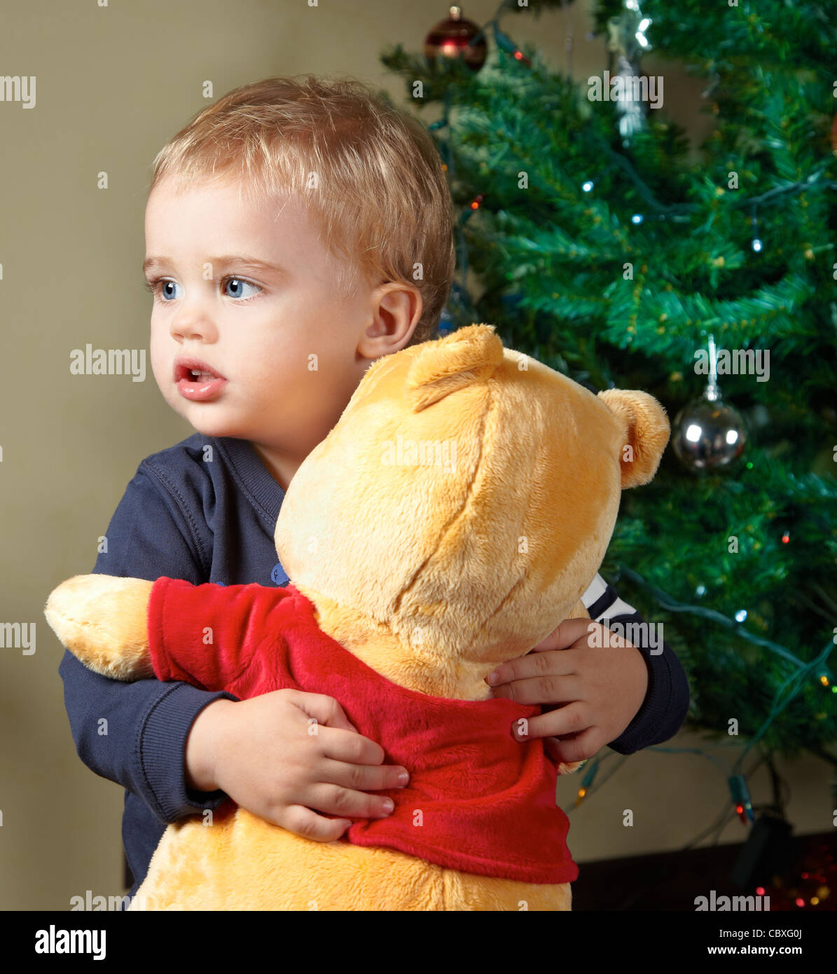 1 year old baby boy by the Christmas tree Stock Photo - Alamy