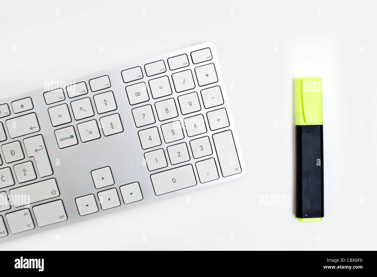 Office desktop, a computer keyboard and a yellow marker Stock Photo - Alamy