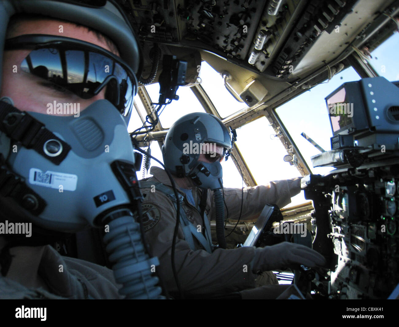 Lt. Col. Tommy Atkinson (right) pilots a C-130 Hercules over northern ...