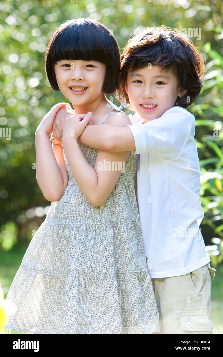 Cute children having fun in garden Stock Photo - Alamy