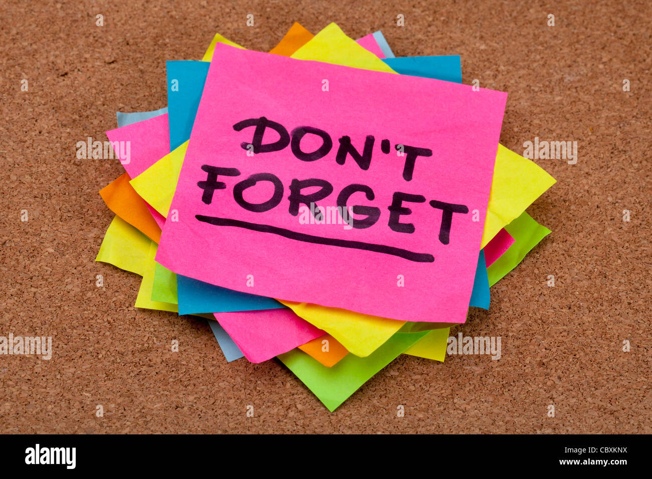 do not forget reminder - a stack of colorful sticky notes on cork ...