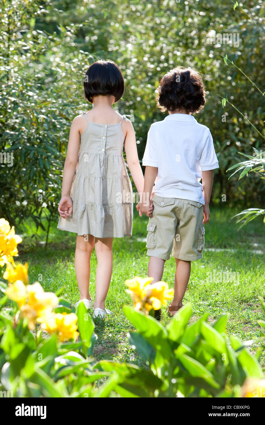 Cute children having fun in garden Stock Photo - Alamy