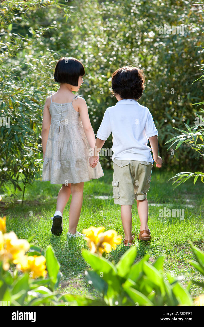 Cute children having fun in garden Stock Photo - Alamy