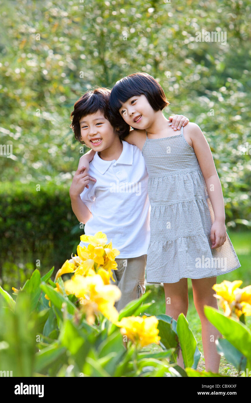 Cute children having fun in garden Stock Photo - Alamy