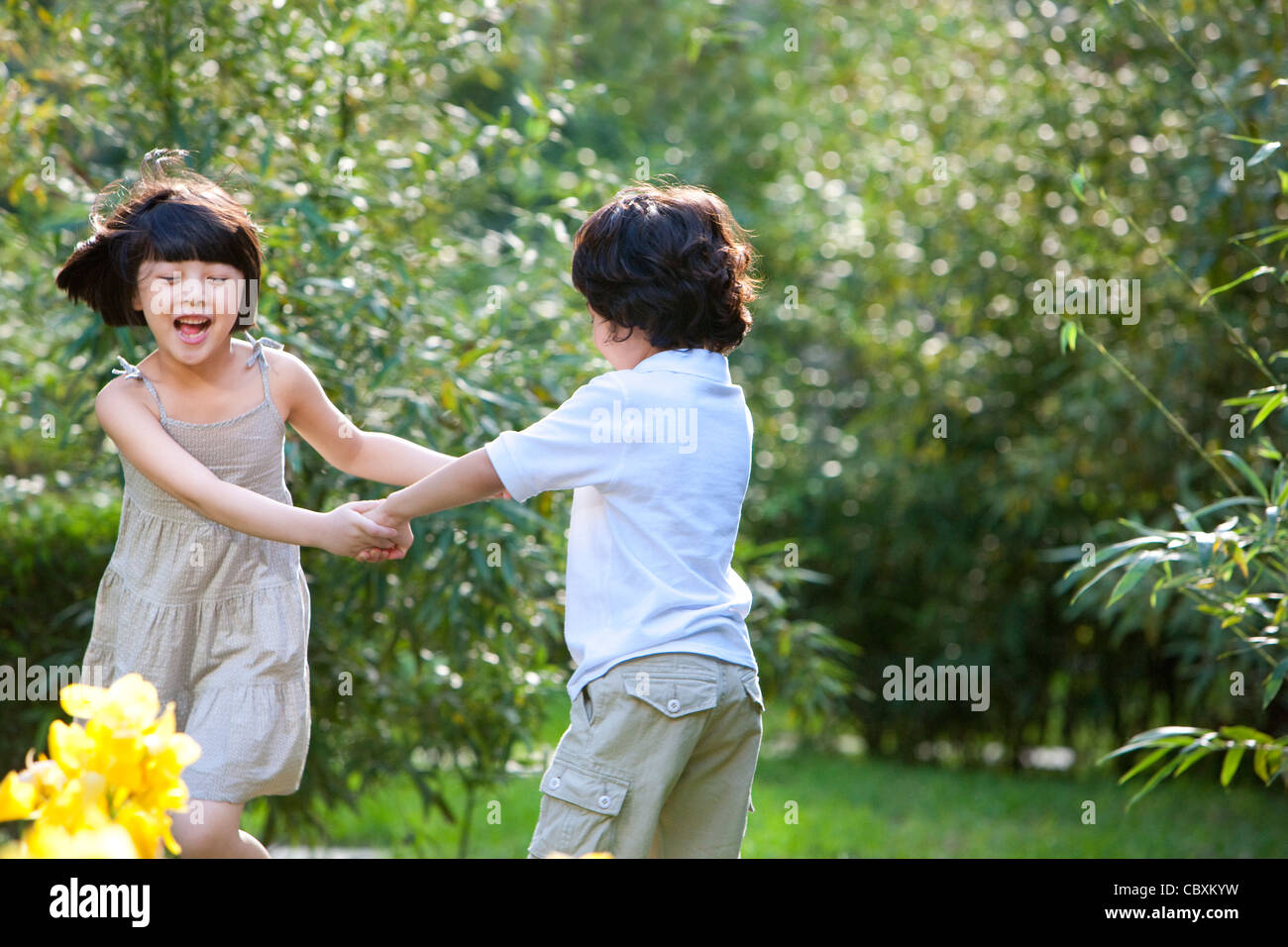 Cute children having fun in garden Stock Photo - Alamy