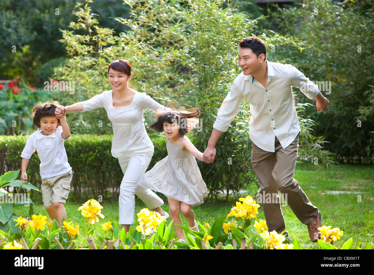 Family having fun in garden Stock Photo - Alamy