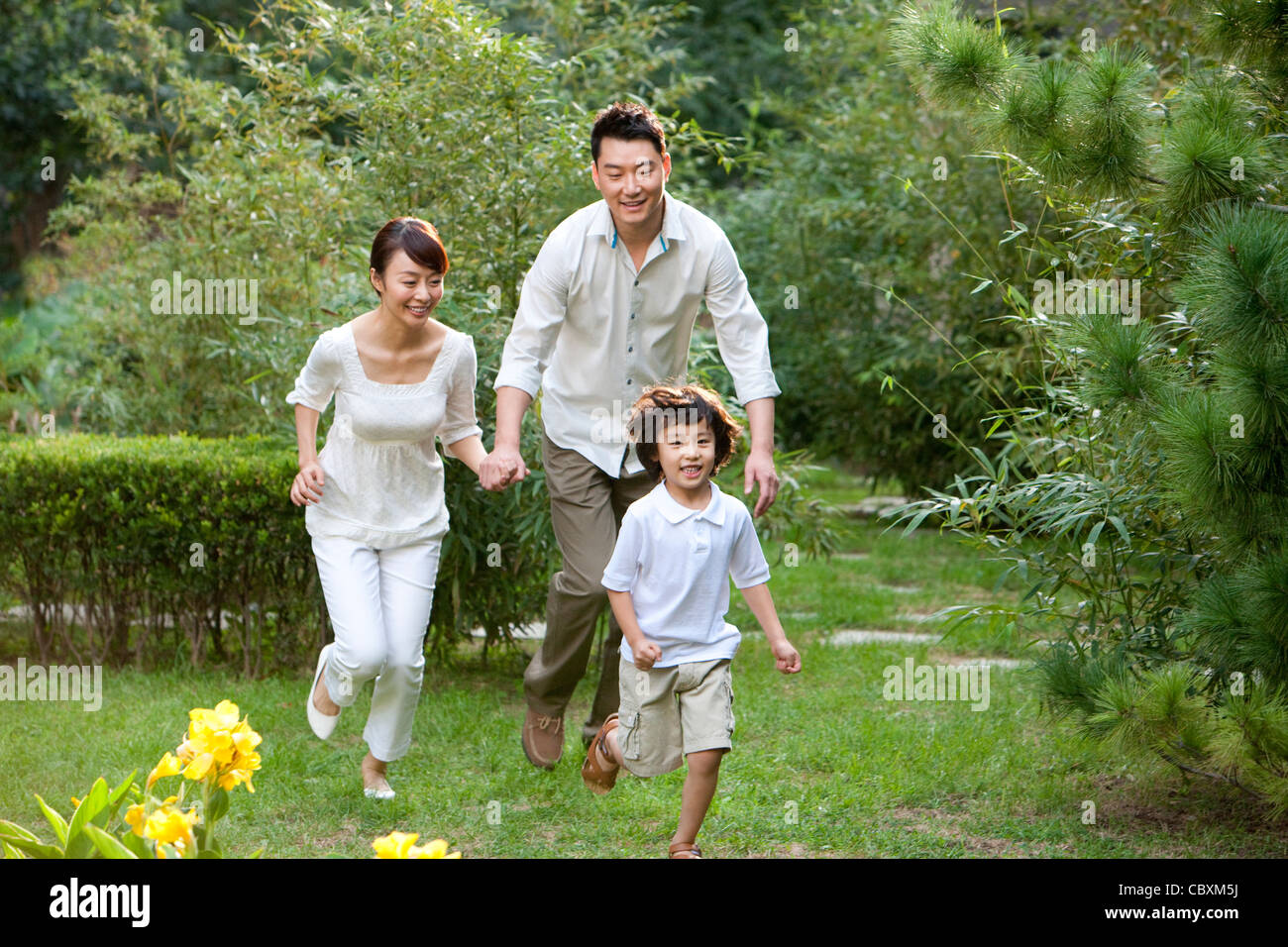 Family having fun in garden Stock Photo - Alamy