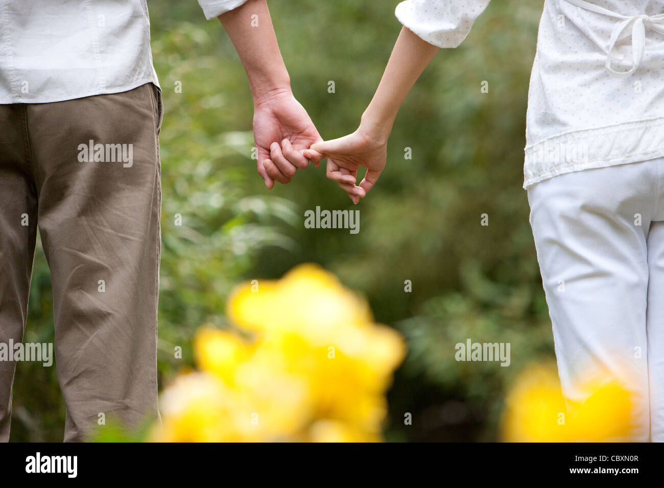 Young couple hand in hand Stock Photo - Alamy