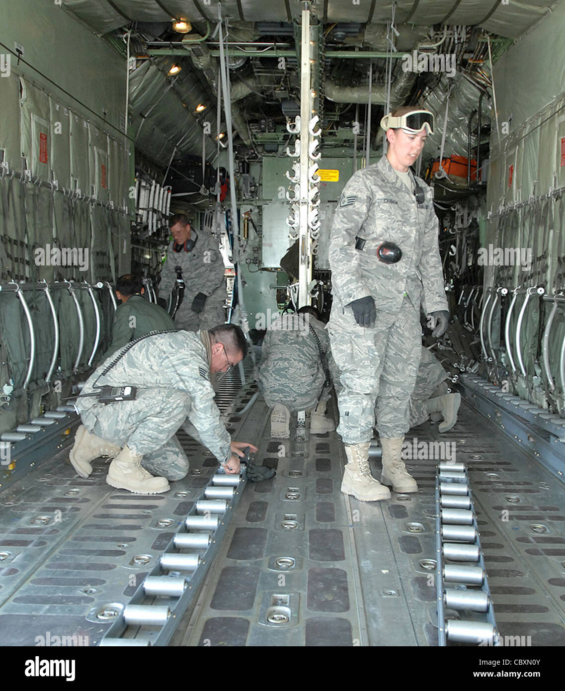 Airmen from the 506th Expeditionary Logistics Readiness Squadron assist ...