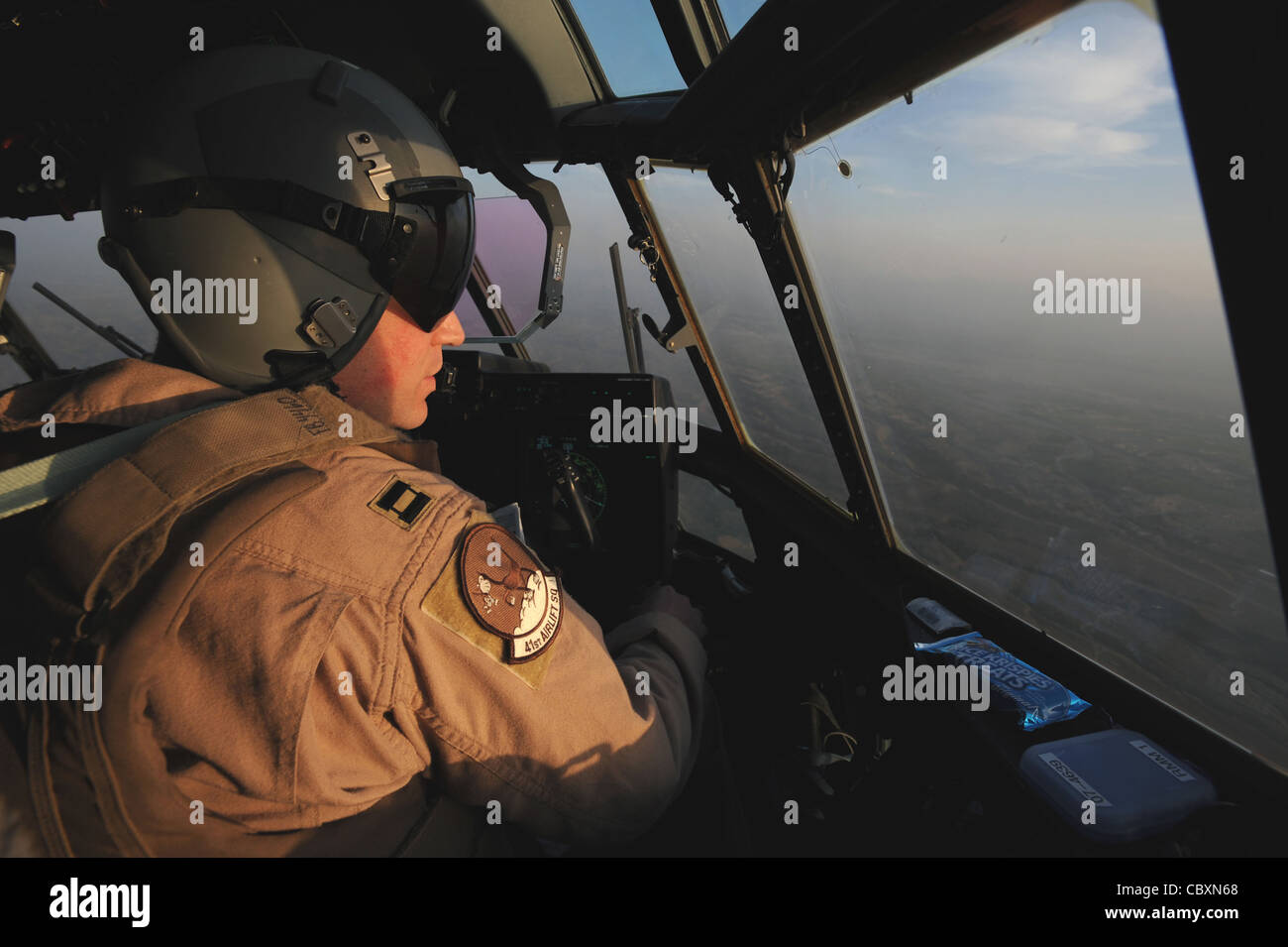 Captain Don Rolleg flies a C-130 Hercules mission March 14 over ...