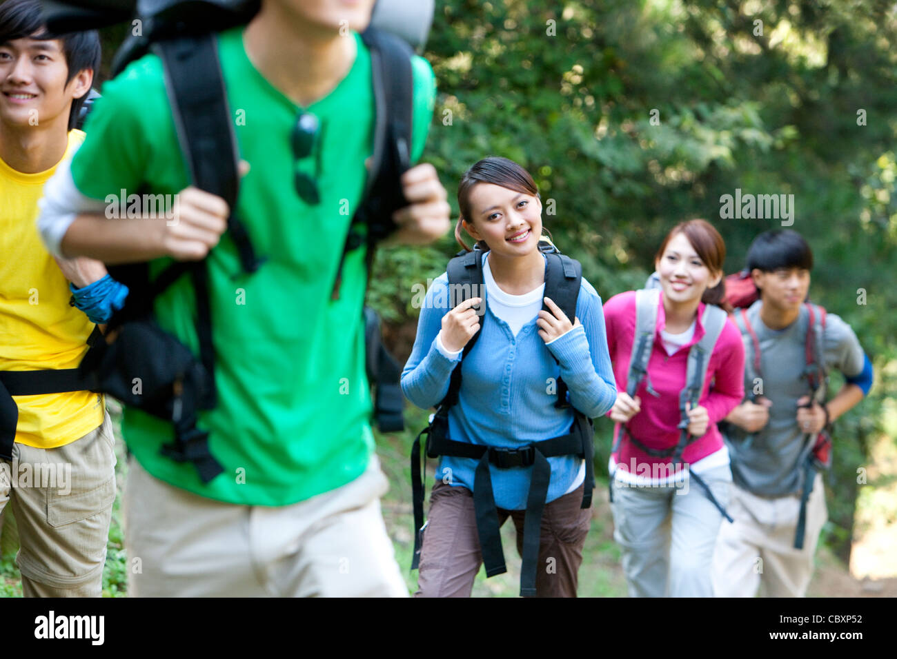 Young people go hiking in mountain Stock Photo - Alamy